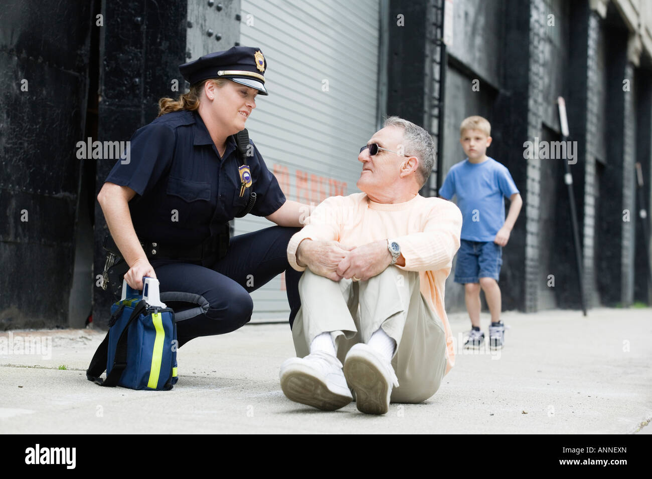 Woman police officer talking to a senior man Stock Photo - Alamy