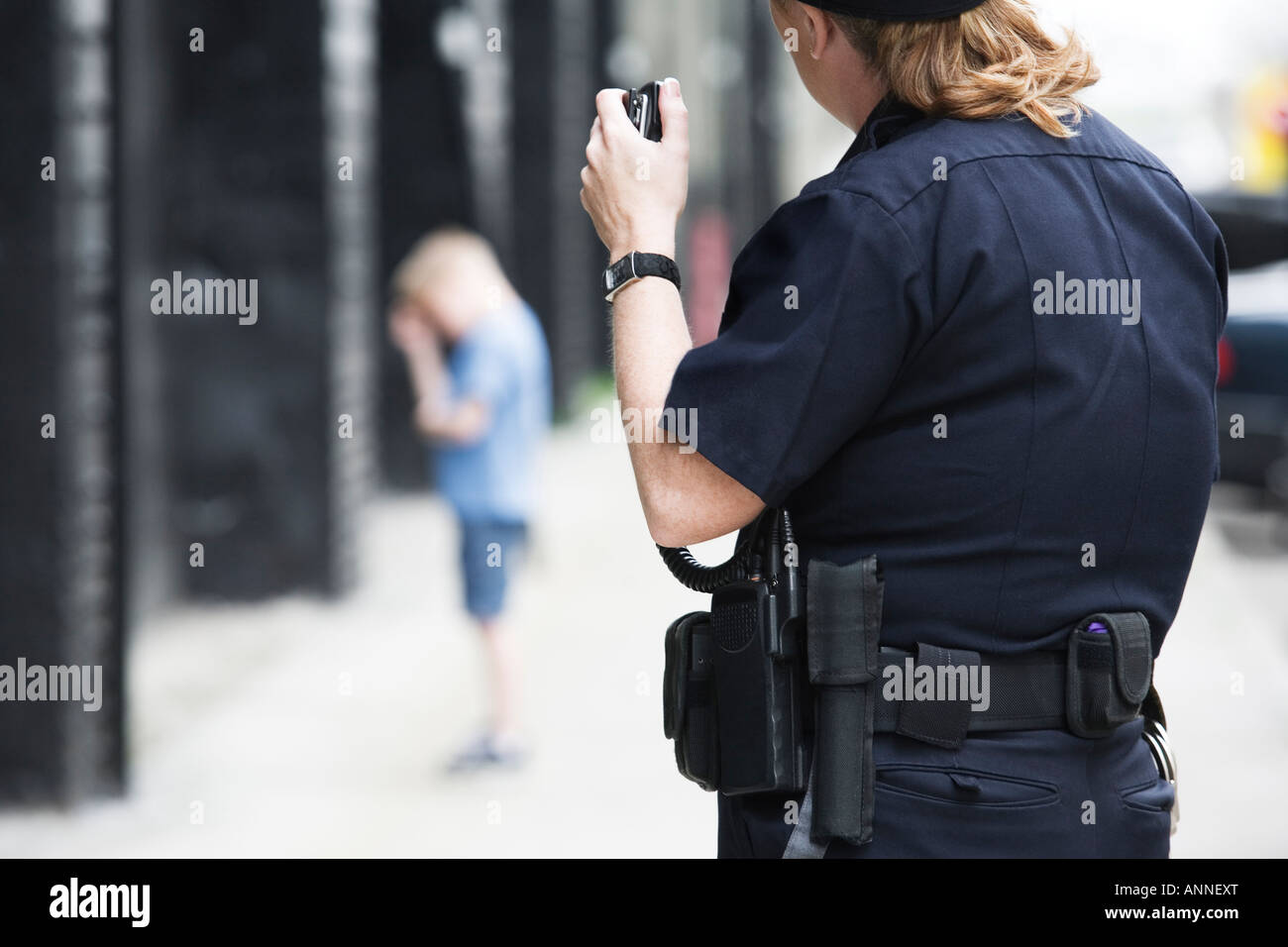 Woman police officer talking on hand mike Stock Photo - Alamy