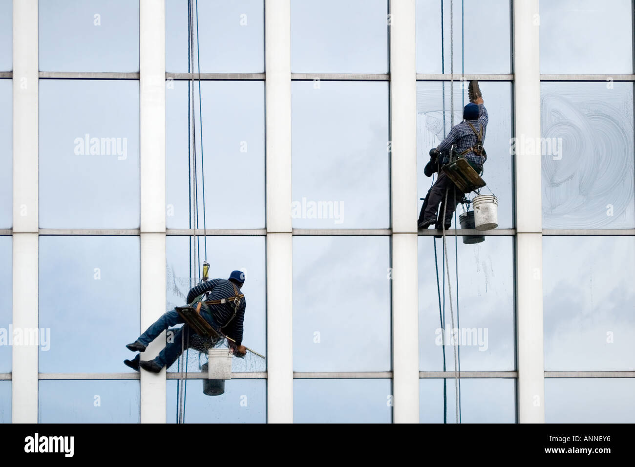 Window washers work high above the city streets Stock Photo - Alamy