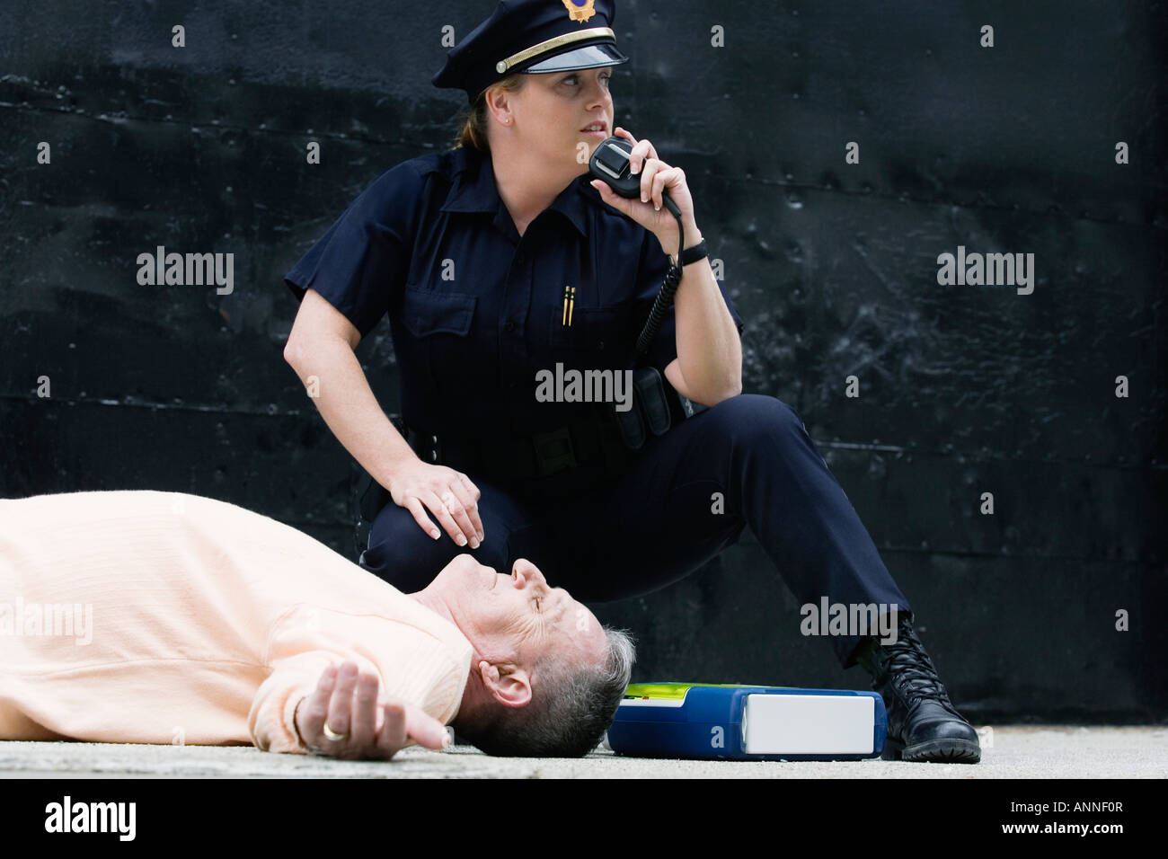 Woman police officer asking for assistance on the hand mike Stock Photo ...