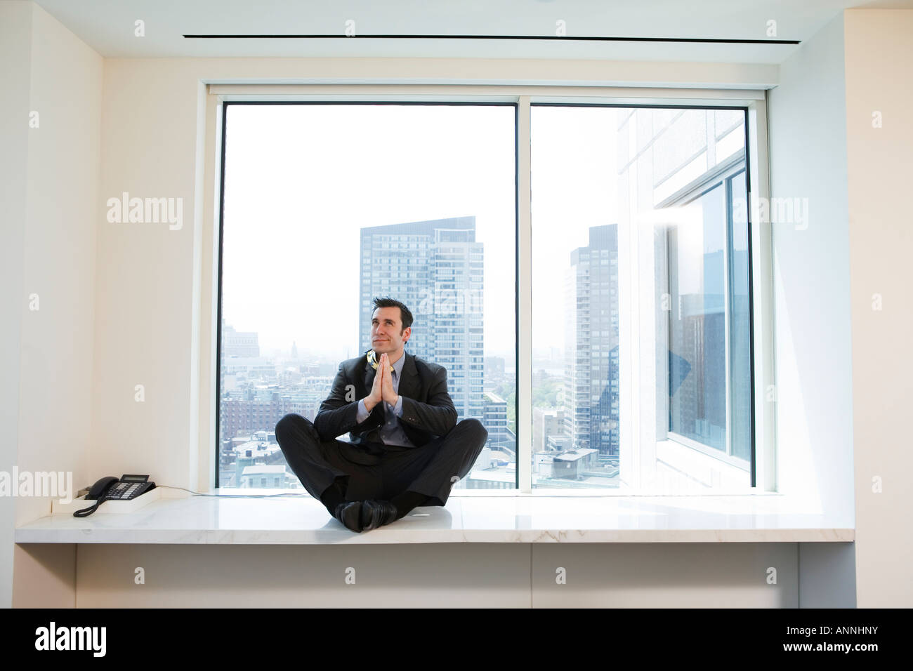 Businessman praying in an office Stock Photo - Alamy