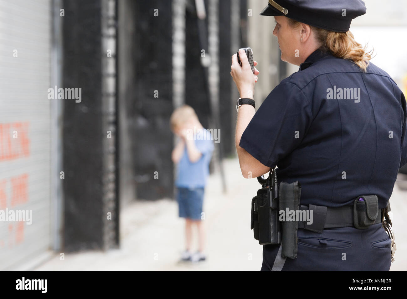 Woman police officer talking on hand mike Stock Photo - Alamy