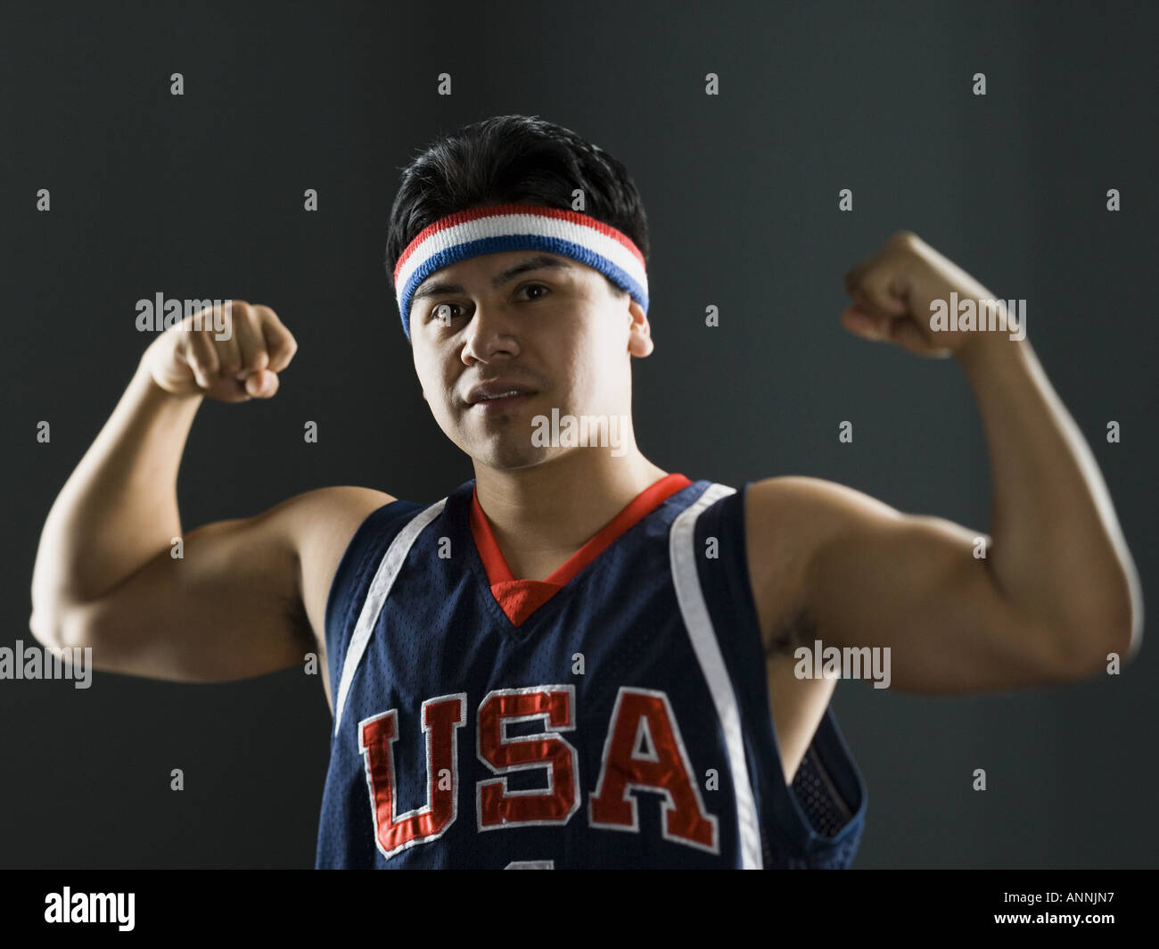 Portrait of a young man flexing his biceps Stock Photo - Alamy