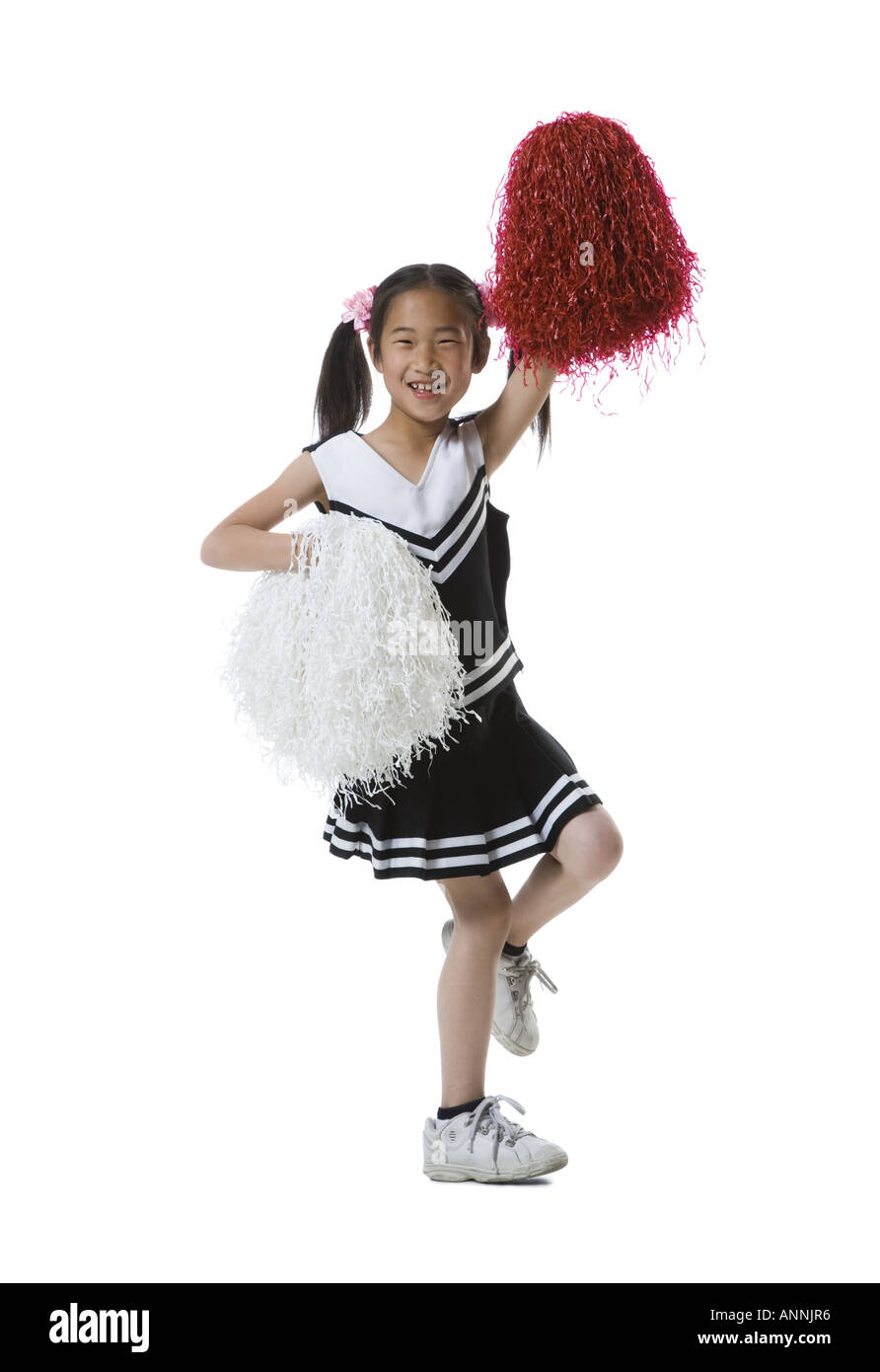Portrait of a cheerleader dancing with pom poms Stock Photo - Alamy