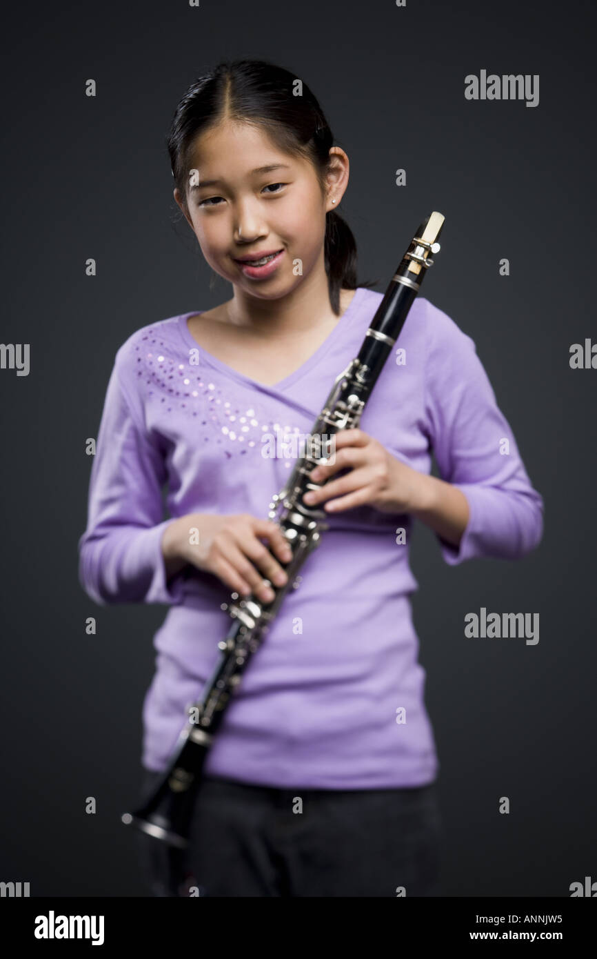 Portrait of a teenage girl holding a clarinet Stock Photo - Alamy