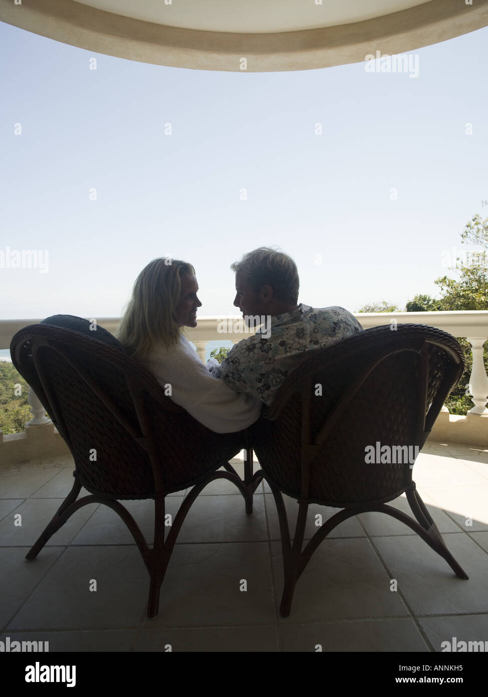 Rear view of a couple on the veranda Stock Photo - Alamy