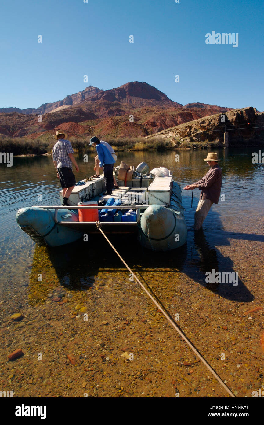 People loading coolers and gear on rafts at Lees Ferry for a whitewater ...
