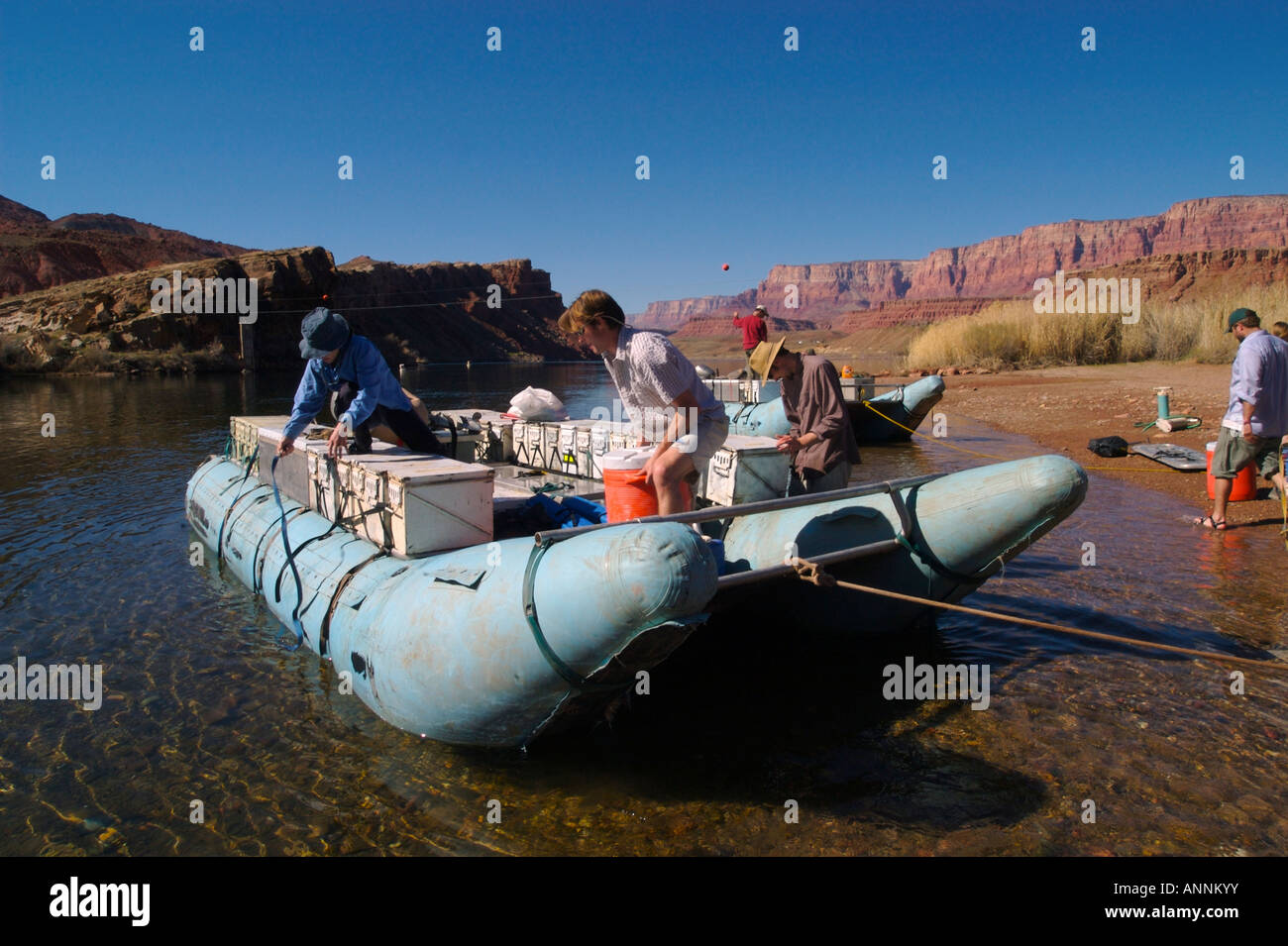 People loading coolers and gear on rafts at Lees Ferry for a whitewater ...