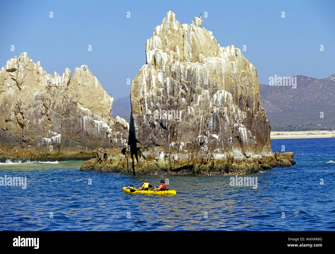 A kayaker explores the reefs and rocks of El Arco in the Sea of Cortez ...