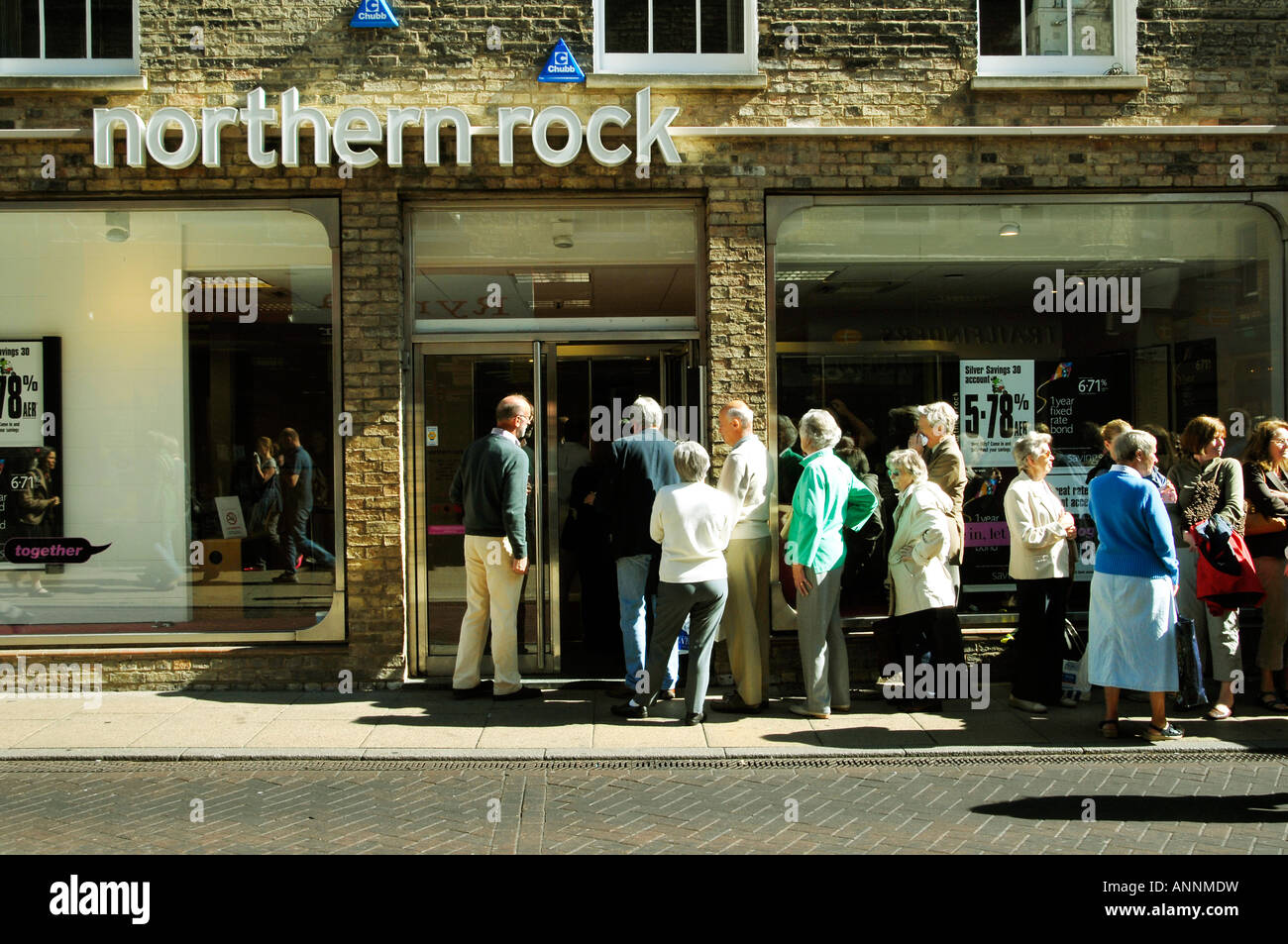 Customers queuing outside the Northern Rock Bank in Cambridge England ...
