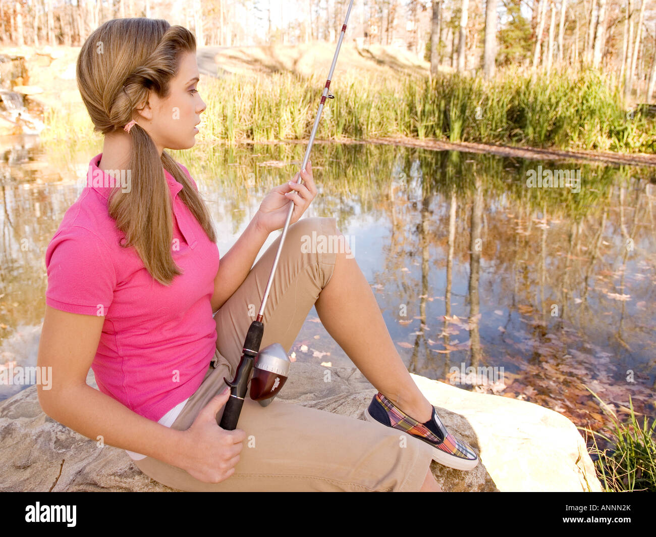 Teen Girl (15-17) Fishing in Pond with Rod and Reel, Side View Stock ...