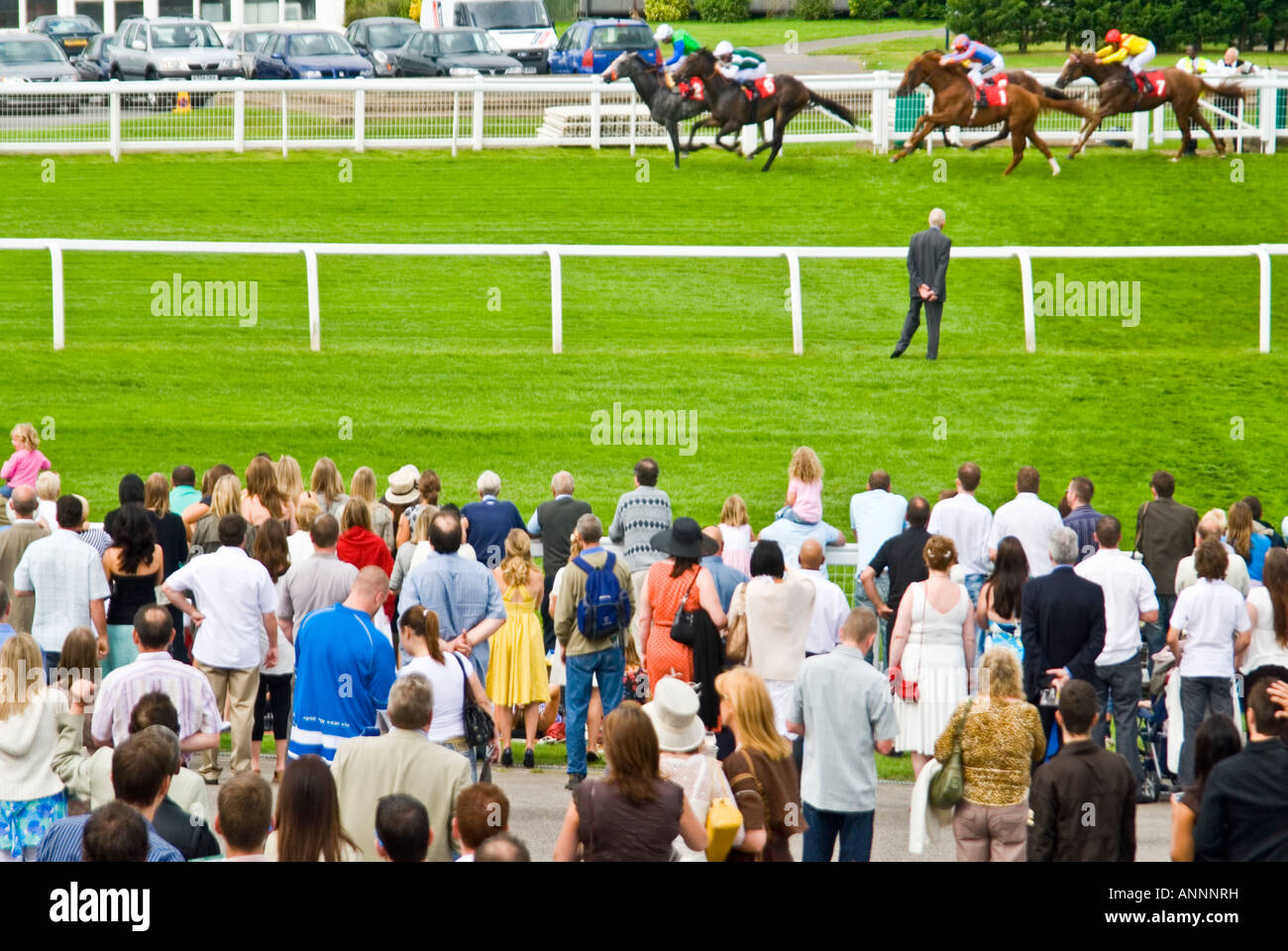 Horizontal view of a crowd of spectators standing against the rails ...