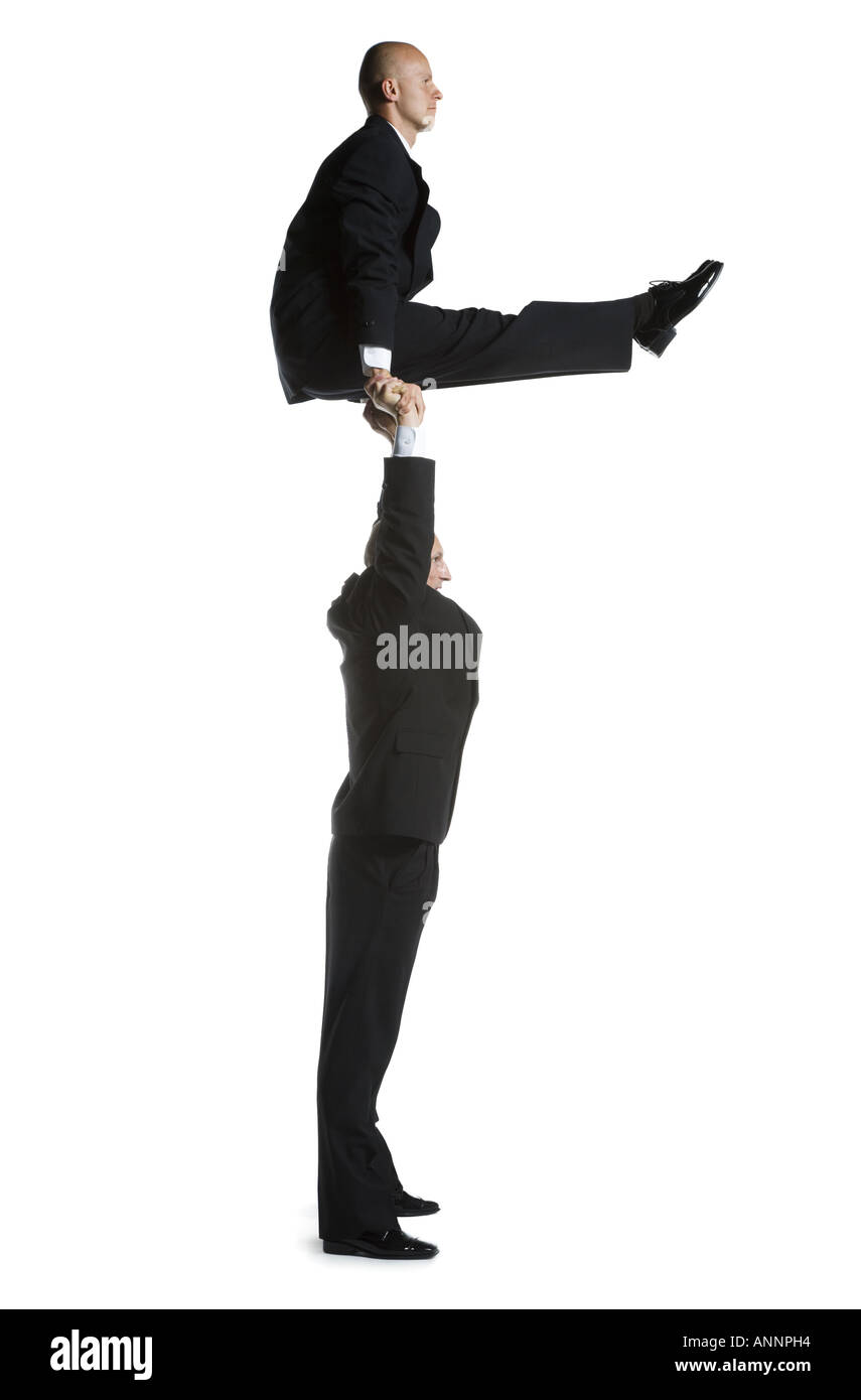Profile of two male acrobats in business suits performing Stock Photo ...