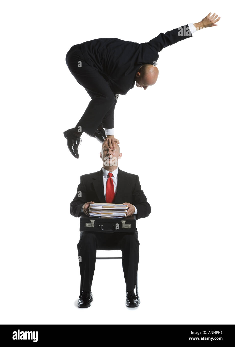 Two male acrobats in business suits performing Stock Photo - Alamy