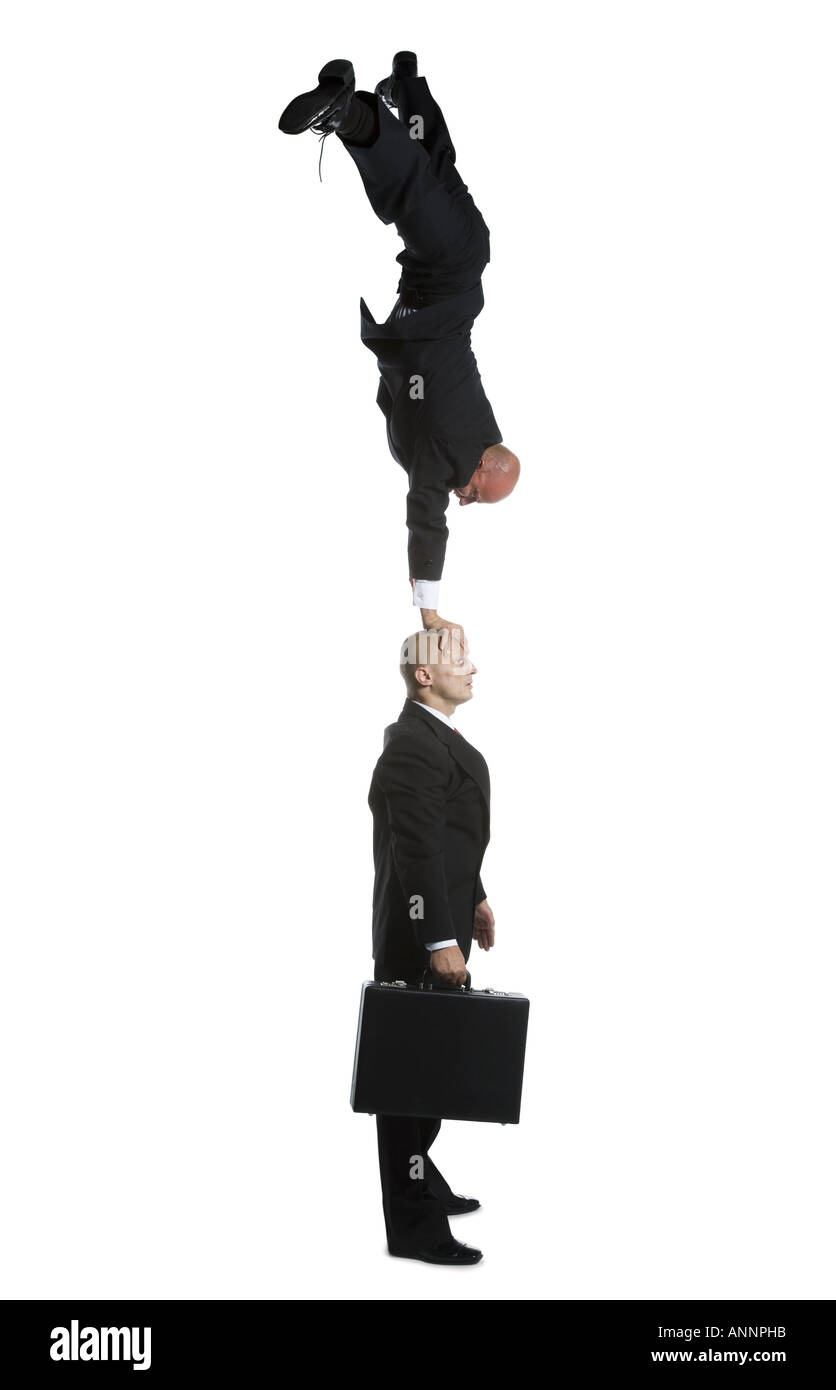 Profile of two male acrobats in business suits performing Stock Photo ...