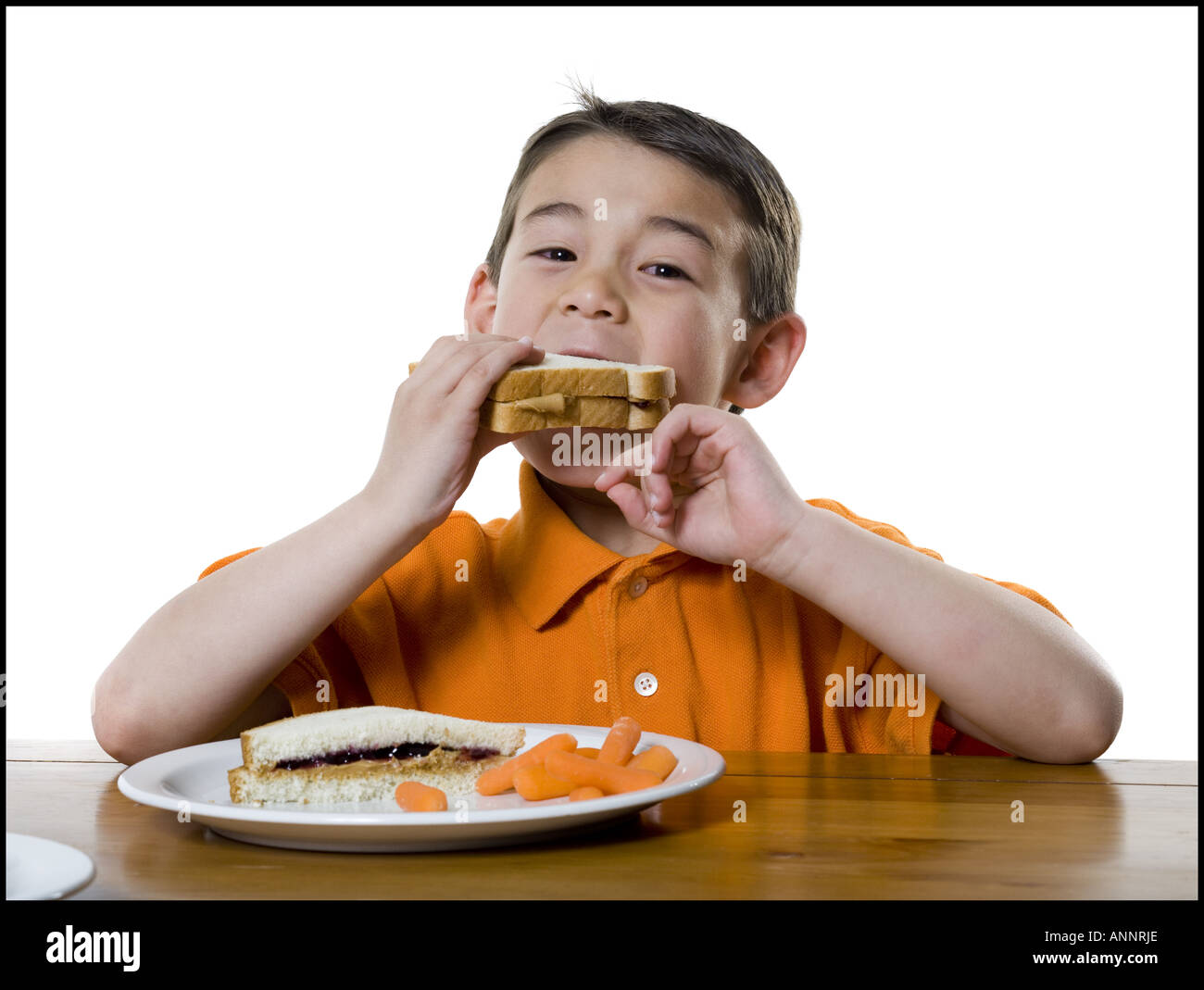 Portrait of a boy eating a sandwich Stock Photo - Alamy