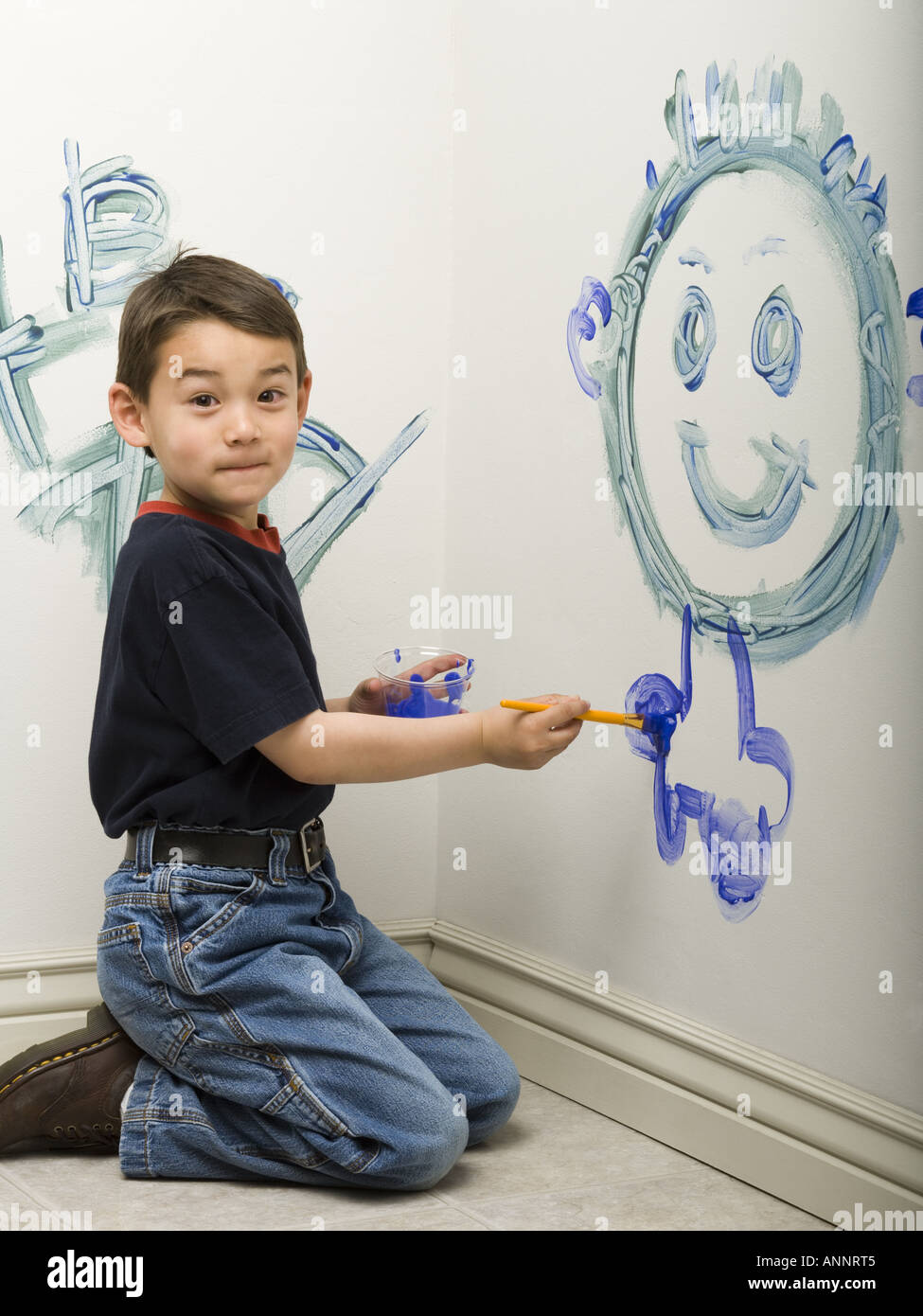 Portrait of a boy painting on a wall Stock Photo - Alamy