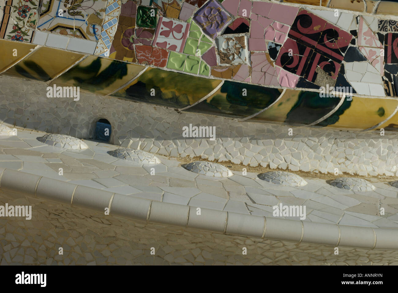close up detail of broken tile mosaics on bench seating at parc guell ...