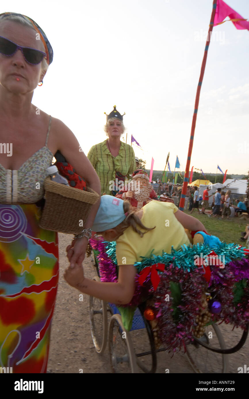Unusual family in costume with pram and Father Christmas figure at ...