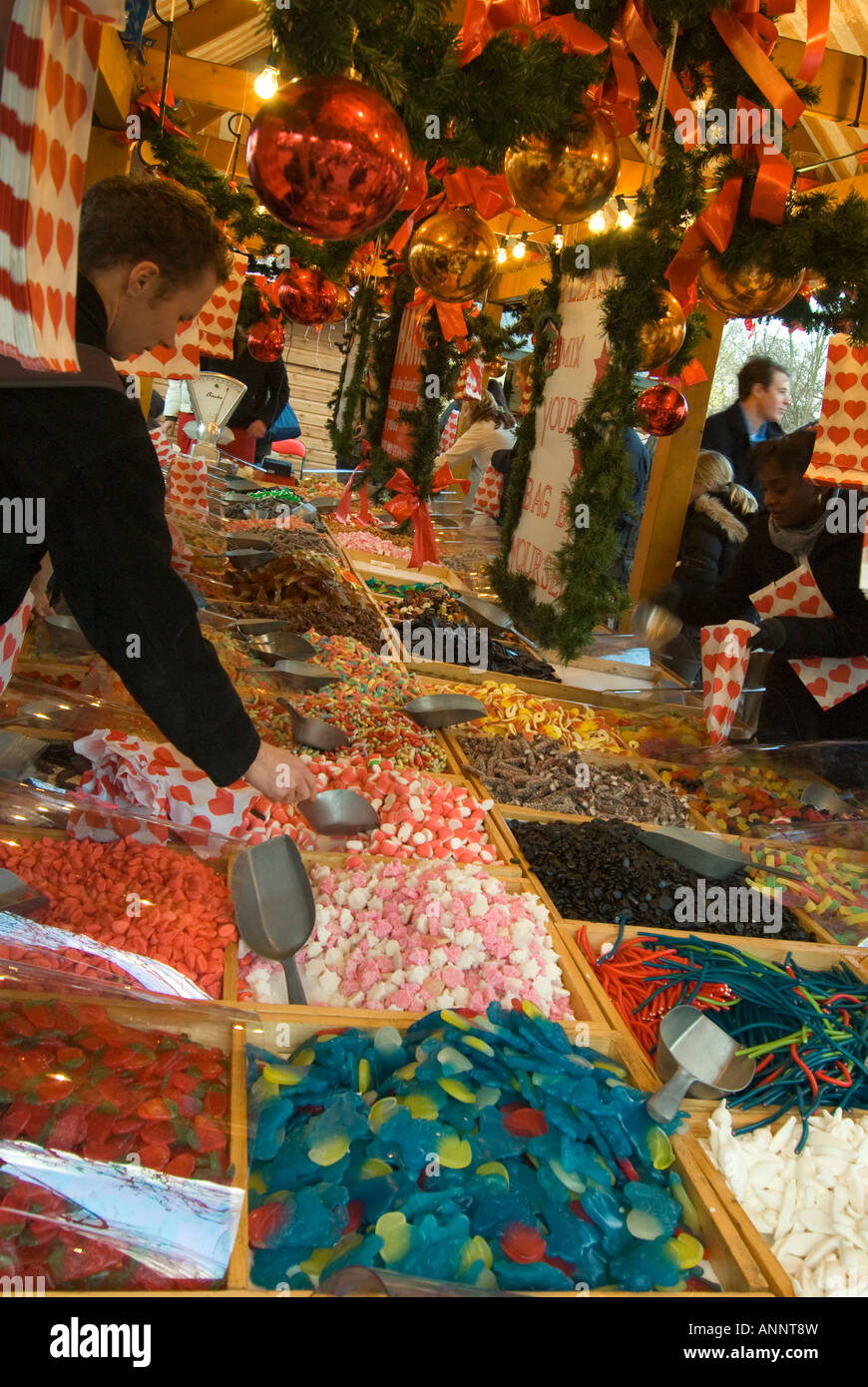 Vertical close up of people helping themselves to sweets from a Pick 'n ...