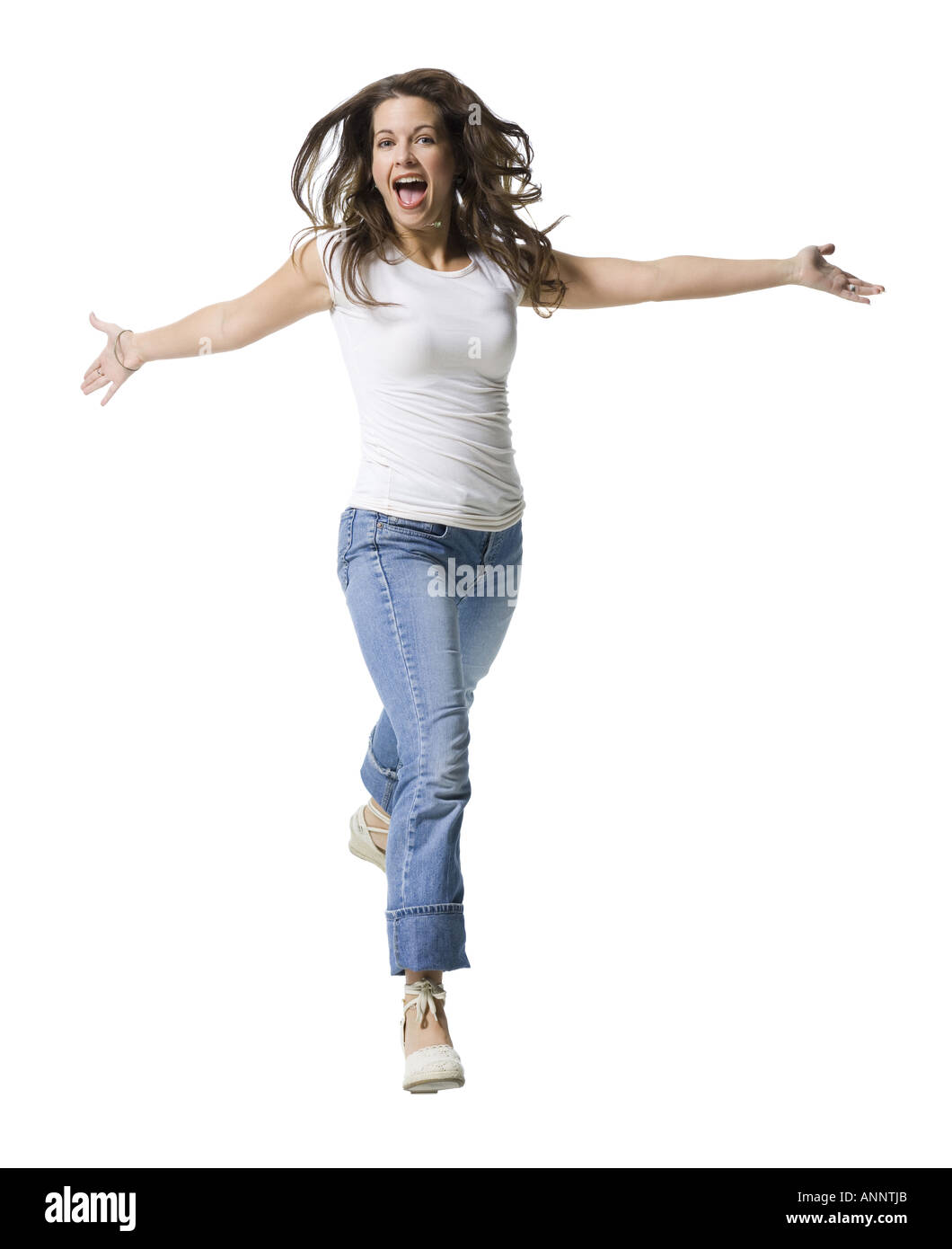 Portrait of a mid adult woman running with her arms outstretched Stock ...