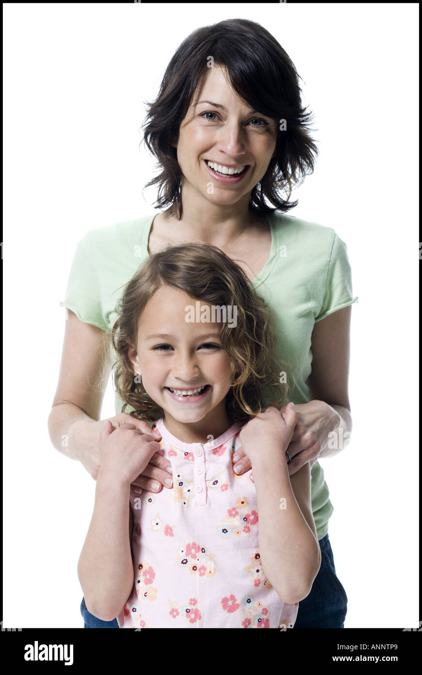 Portrait of a girl standing with her mother Stock Photo - Alamy