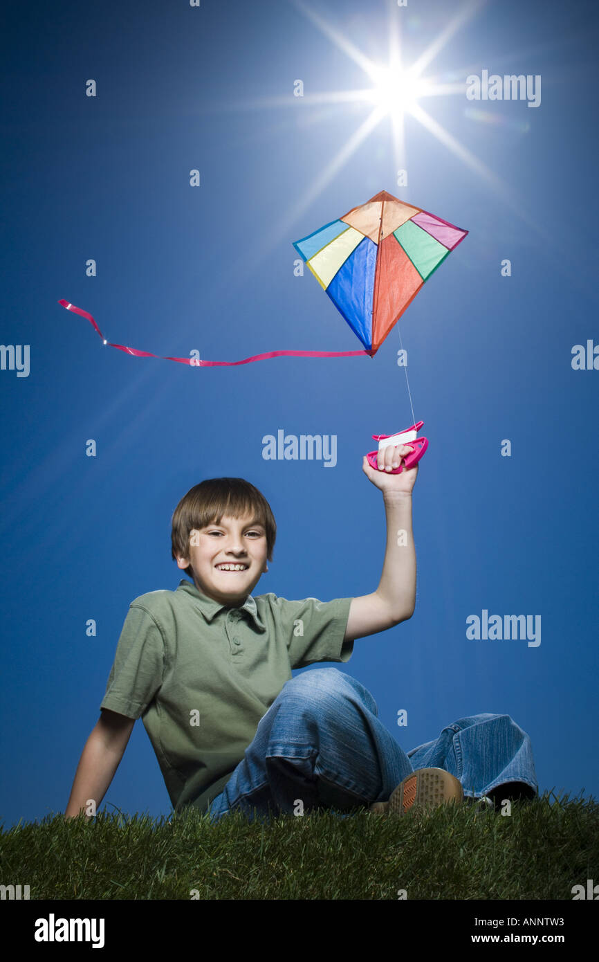 Portrait of a boy flying a kite Stock Photo - Alamy