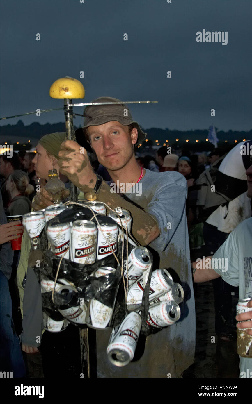 Mud covered man at night after a few beers with cans of lager at ...