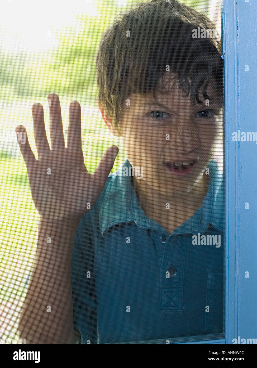 Portrait of a boy peeping through a window Stock Photo - Alamy