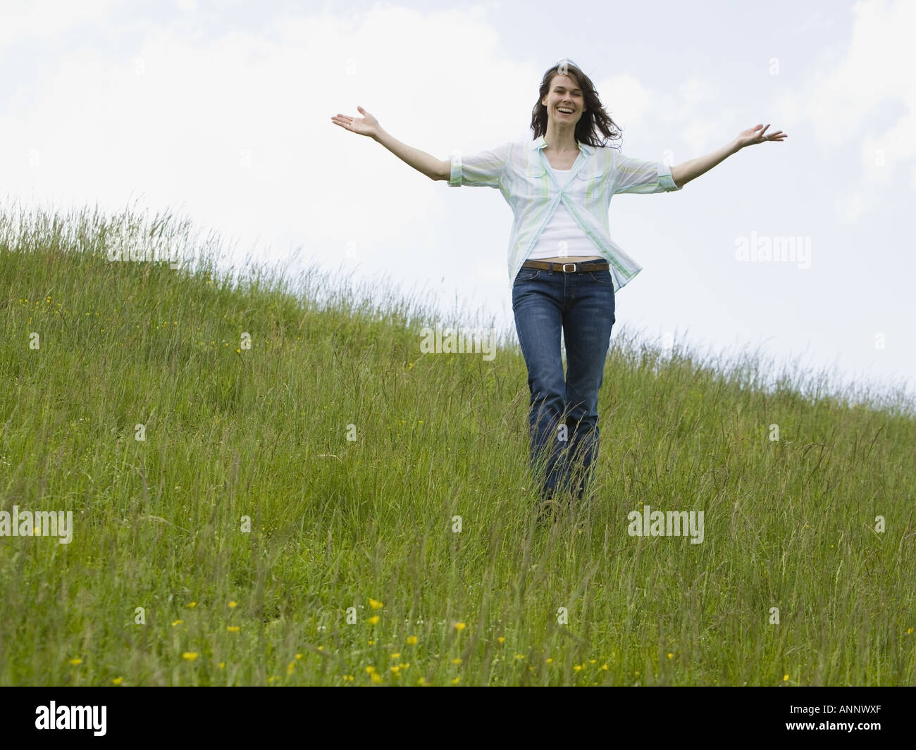 woman with her arms outstretched in a field Stock Photo - Alamy