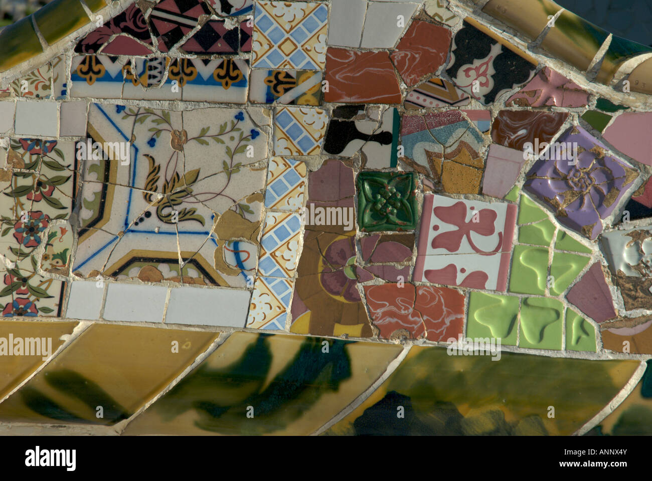 close up detail of broken tile mosaics on bench seating at parc guell ...