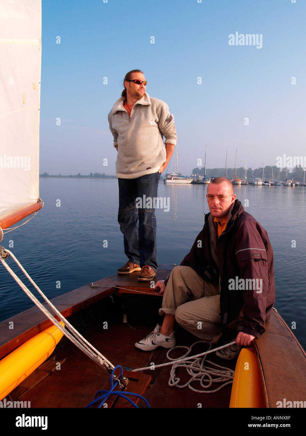 Two men on a sailing boat Stock Photo - Alamy