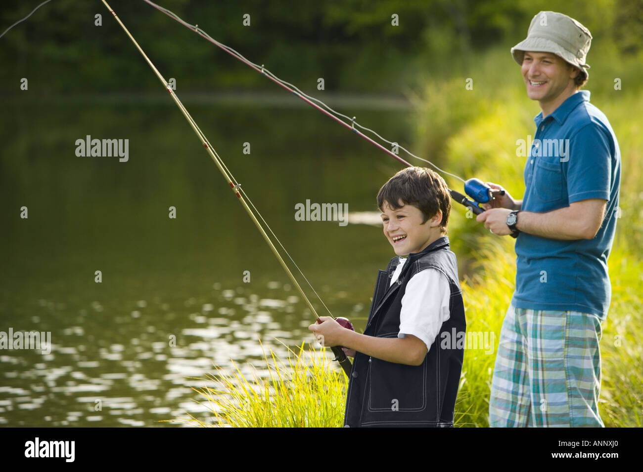Profile of a man and his son fishing Stock Photo - Alamy