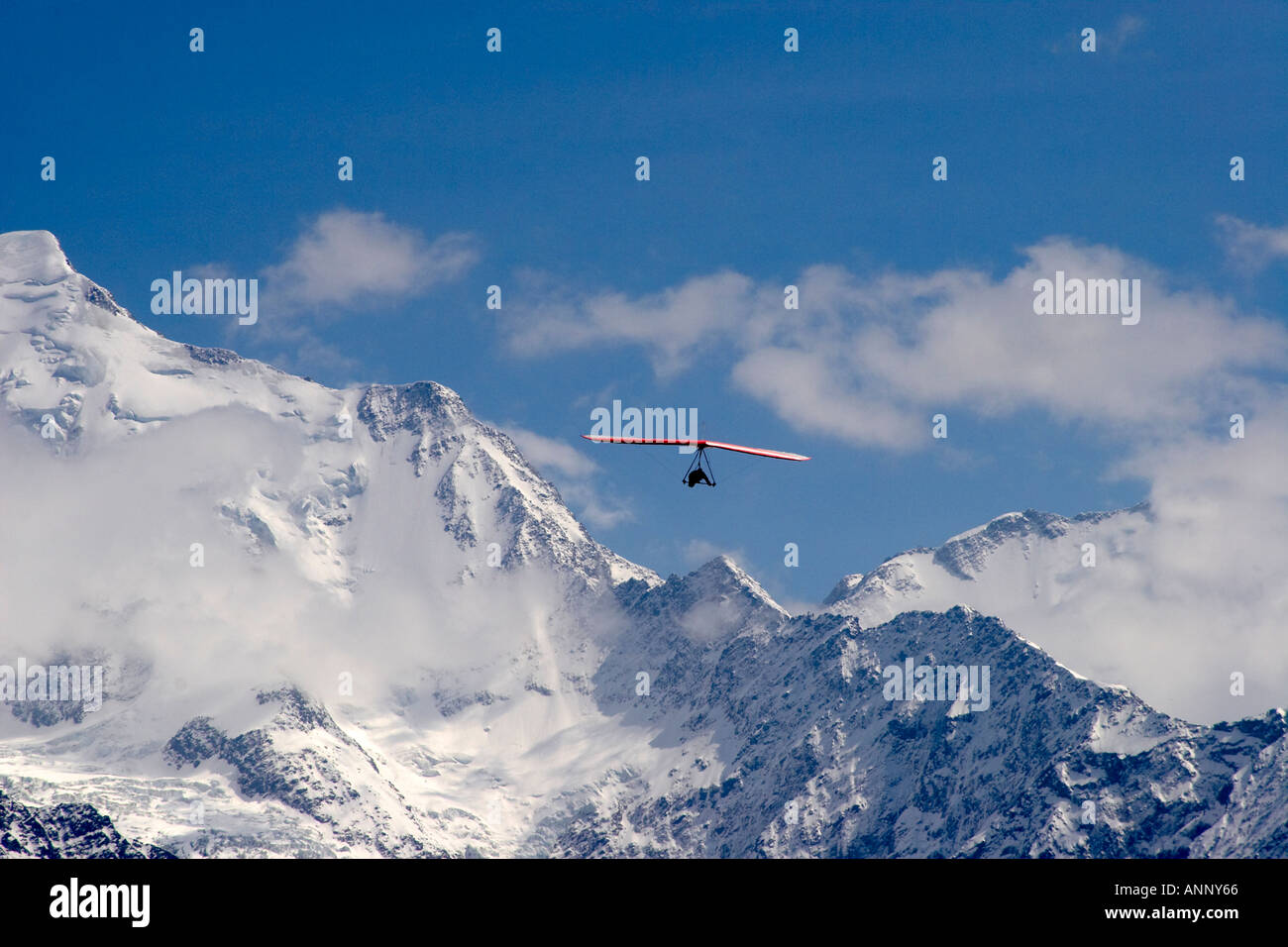 Hang gliding pilots flying hang gliders in snowy mountains of French ...