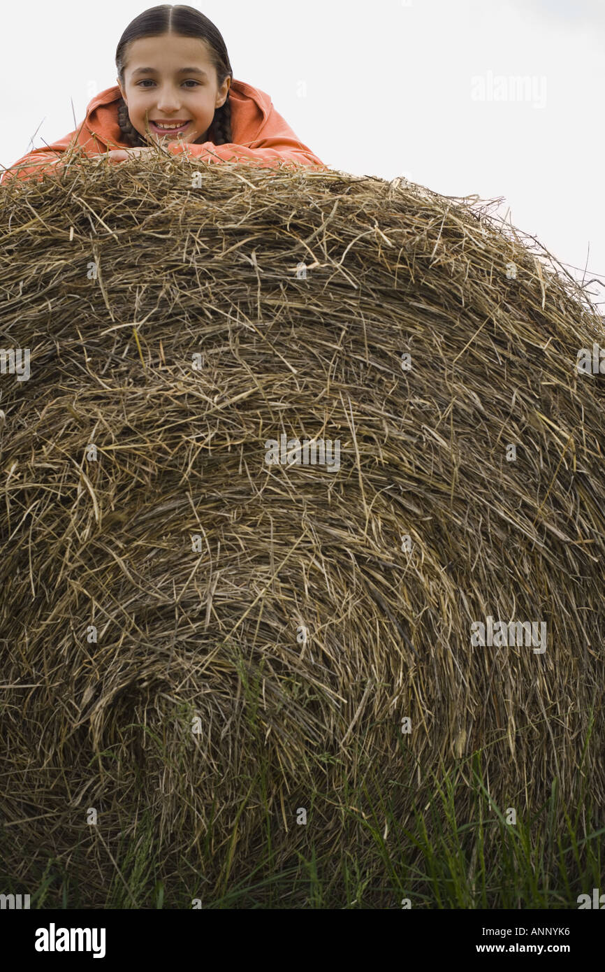 Portrait of a girl lying on a haystack Stock Photo - Alamy