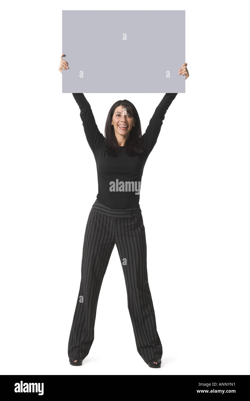 Portrait of a mid adult woman lifting up a placard Stock Photo - Alamy