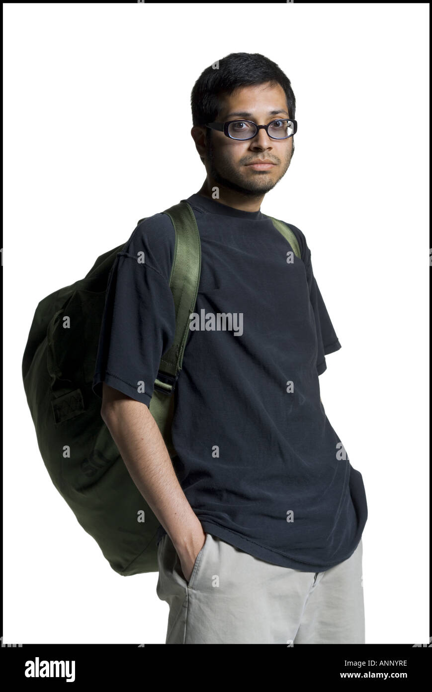Portrait of a young man carrying a backpack with his hands in his ...