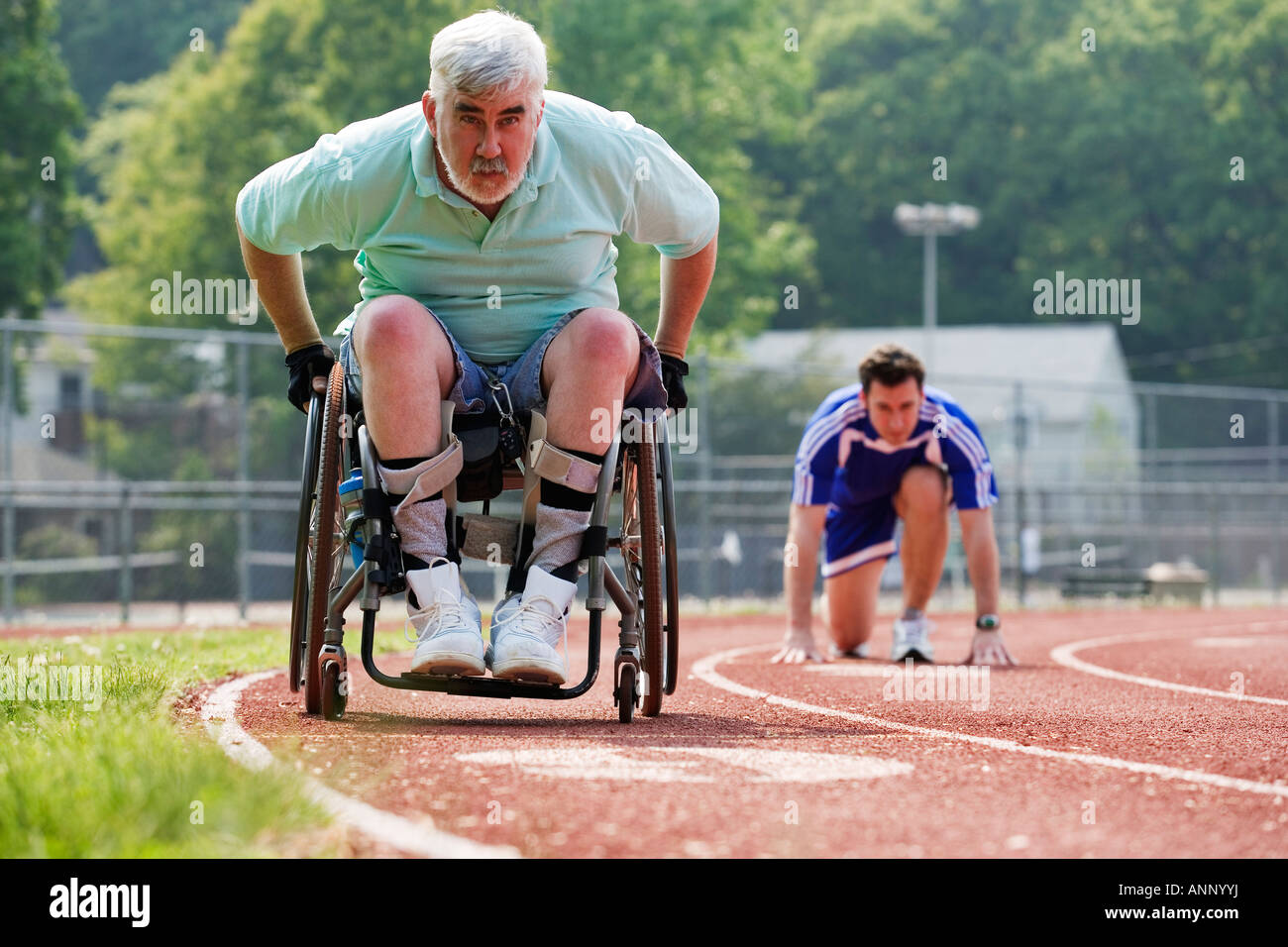 Young man racing with a handicapped senior man on a racetrack Stock ...
