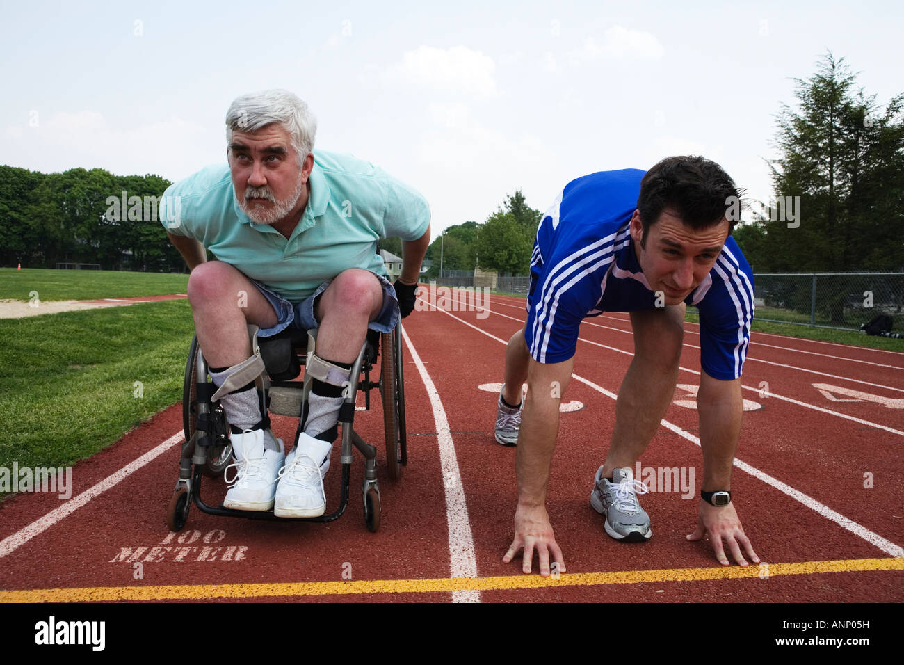 Young man racing with a handicapped senior man on a racetrack Stock ...