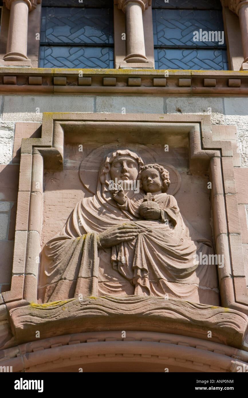 Stone bas relief of Mary and baby Jesus on front of Herz Jesu Kirche ...