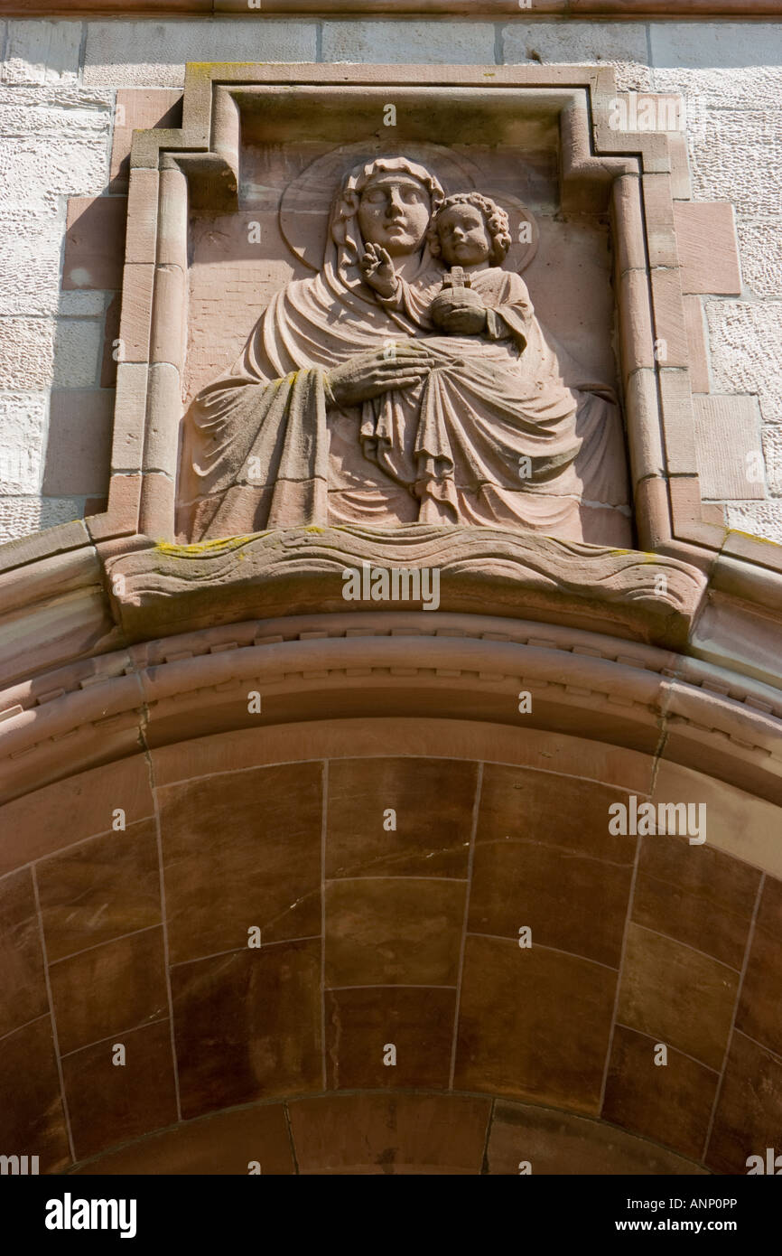 Stone bas relief of Mary and baby Jesus on front of Herz Jesu Kirche ...