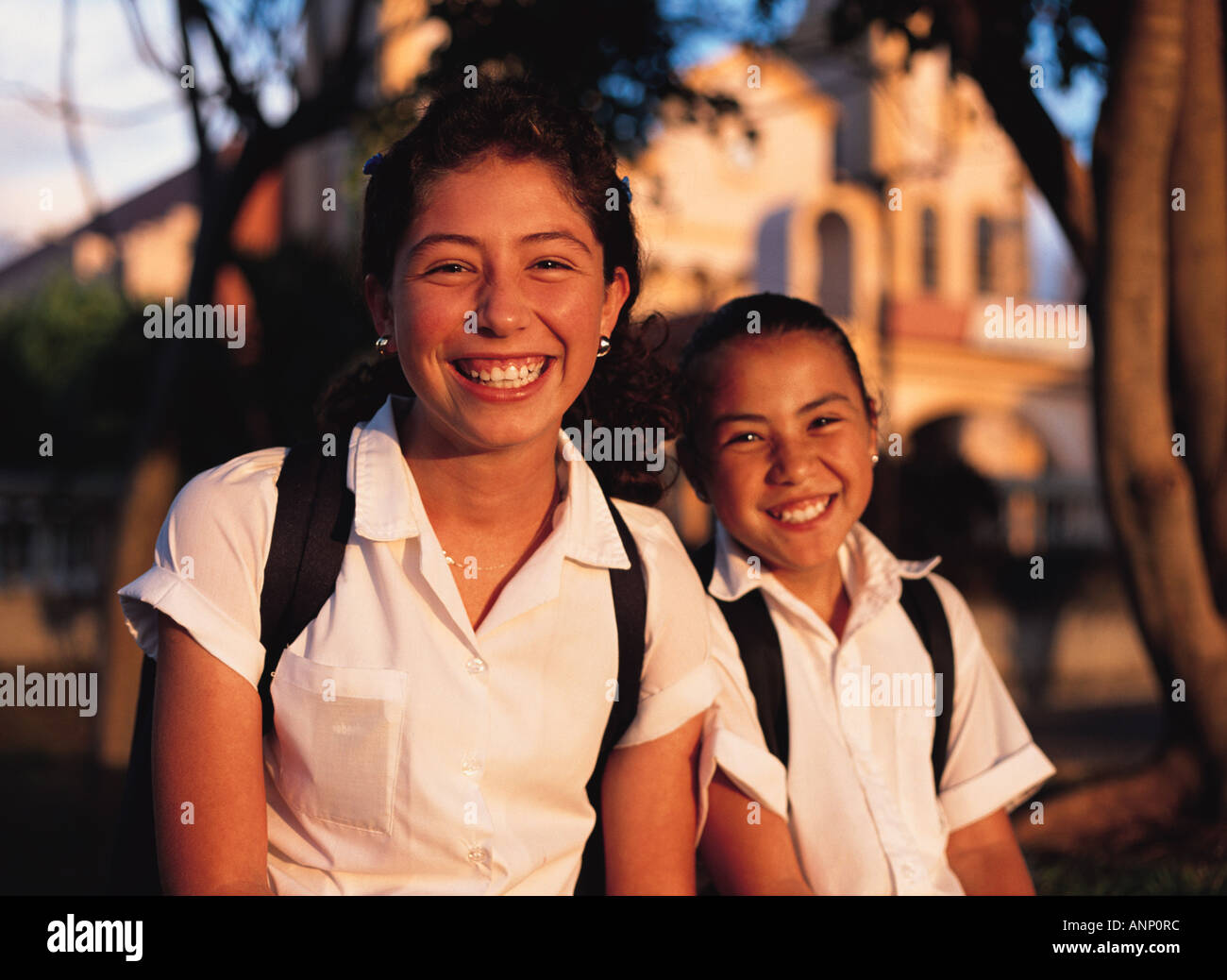 Portrait of two school girls smiling Stock Photo - Alamy