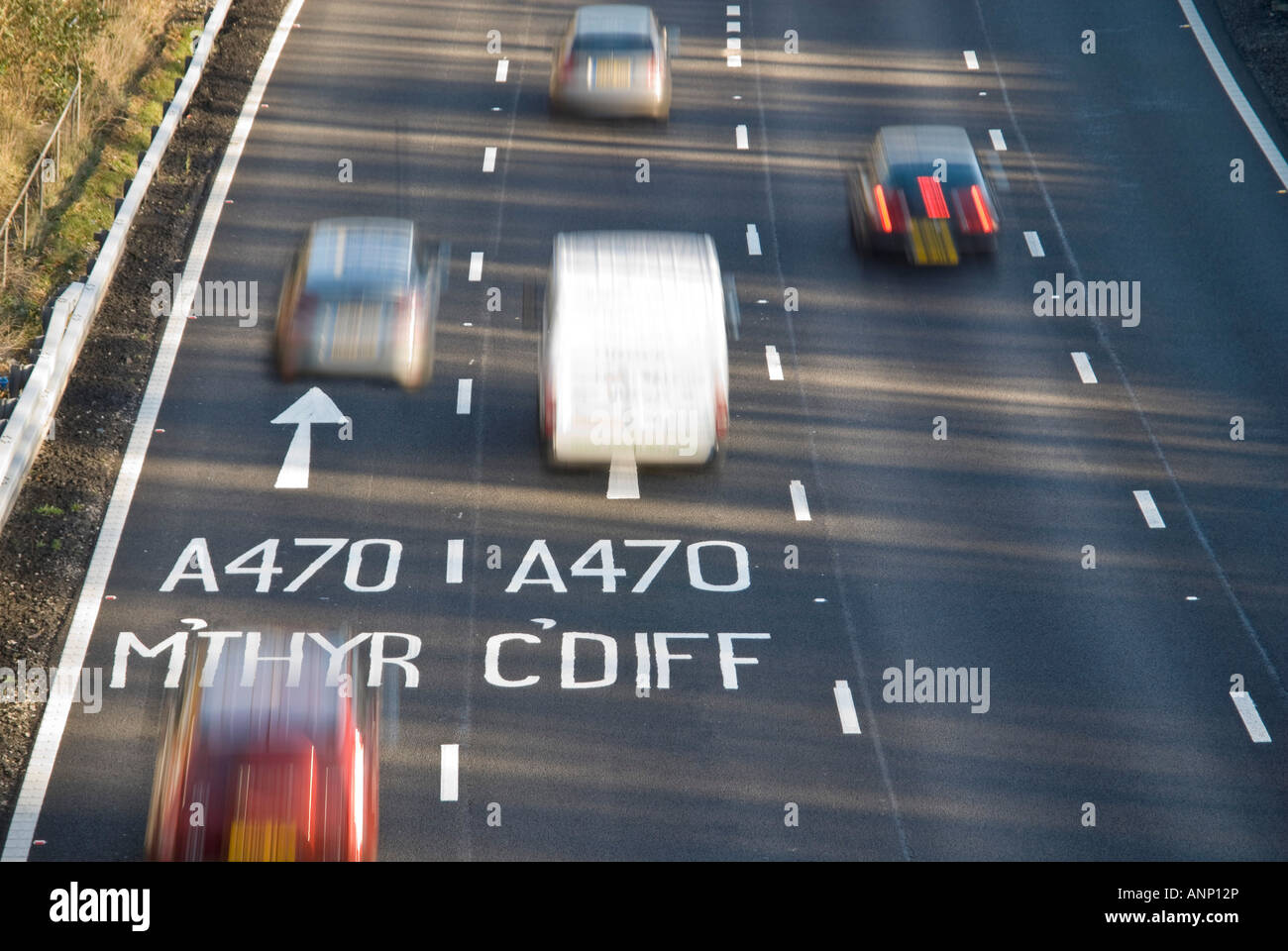 Horizontal close up of road markings and place names on the M4 motorway ...