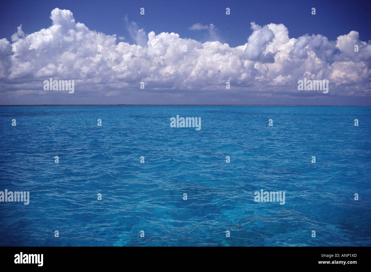 View of a blue sea with clouds overhead Stock Photo - Alamy