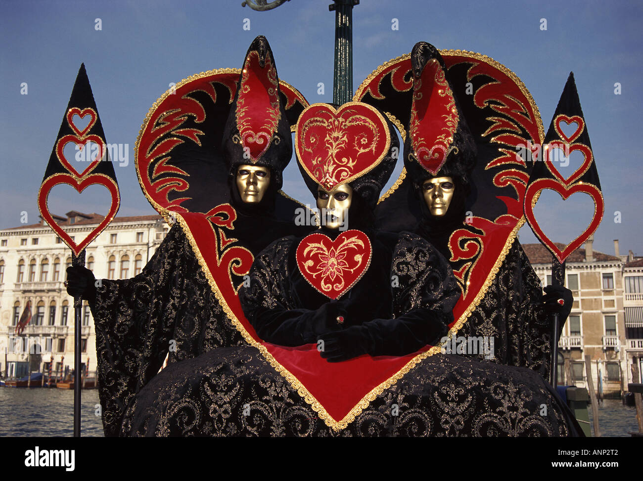 Three people dressed in masquerade costumes Stock Photo - Alamy
