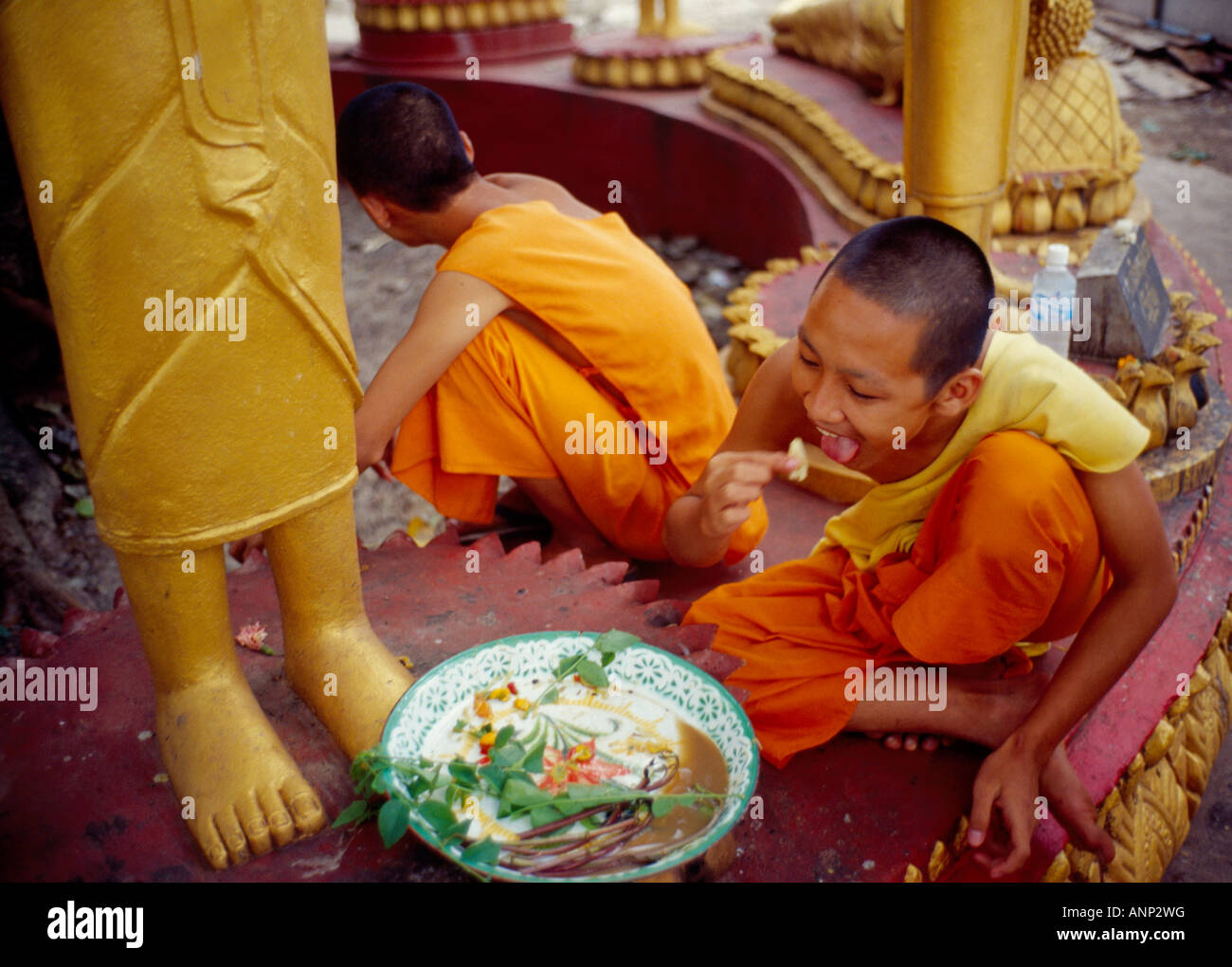 Monk eating under buddhist statue hi-res stock photography and images ...