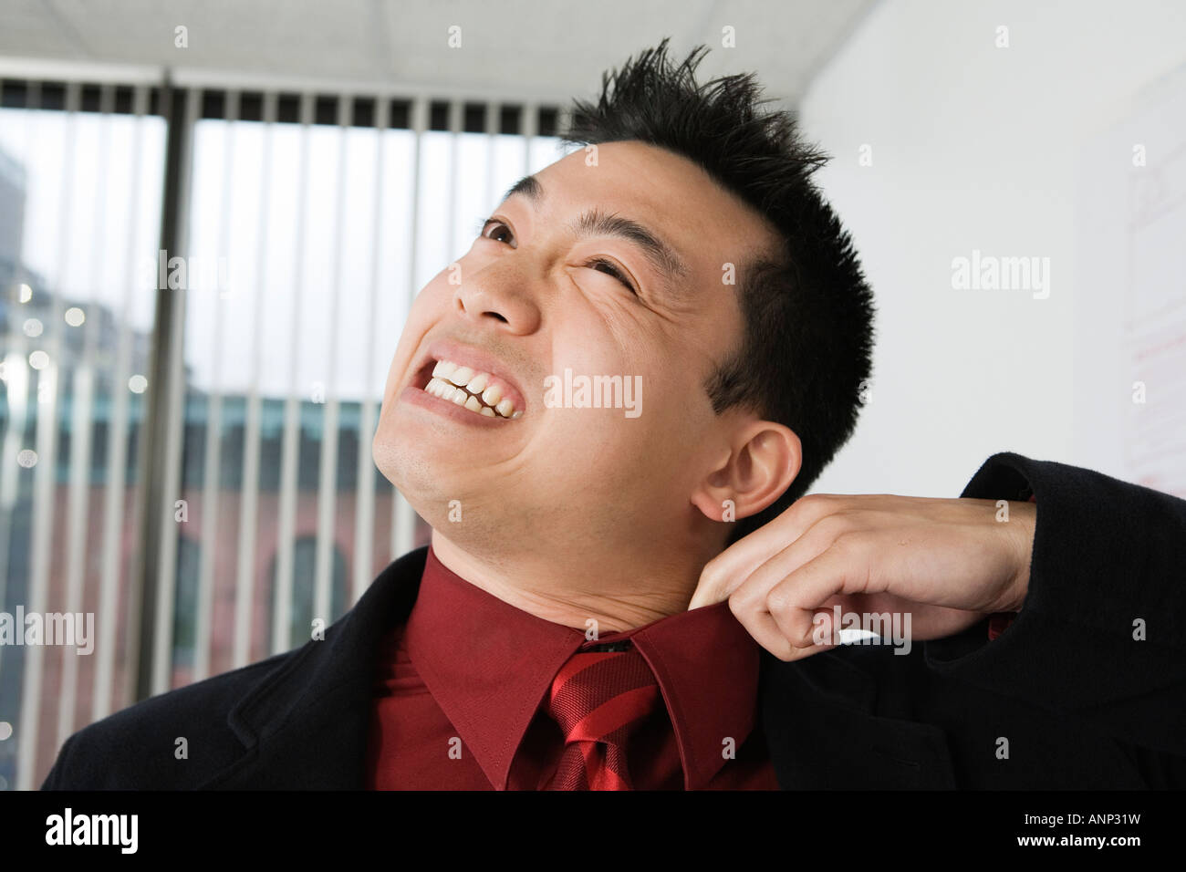 View of a mid adult man adjusting his collar Stock Photo - Alamy
