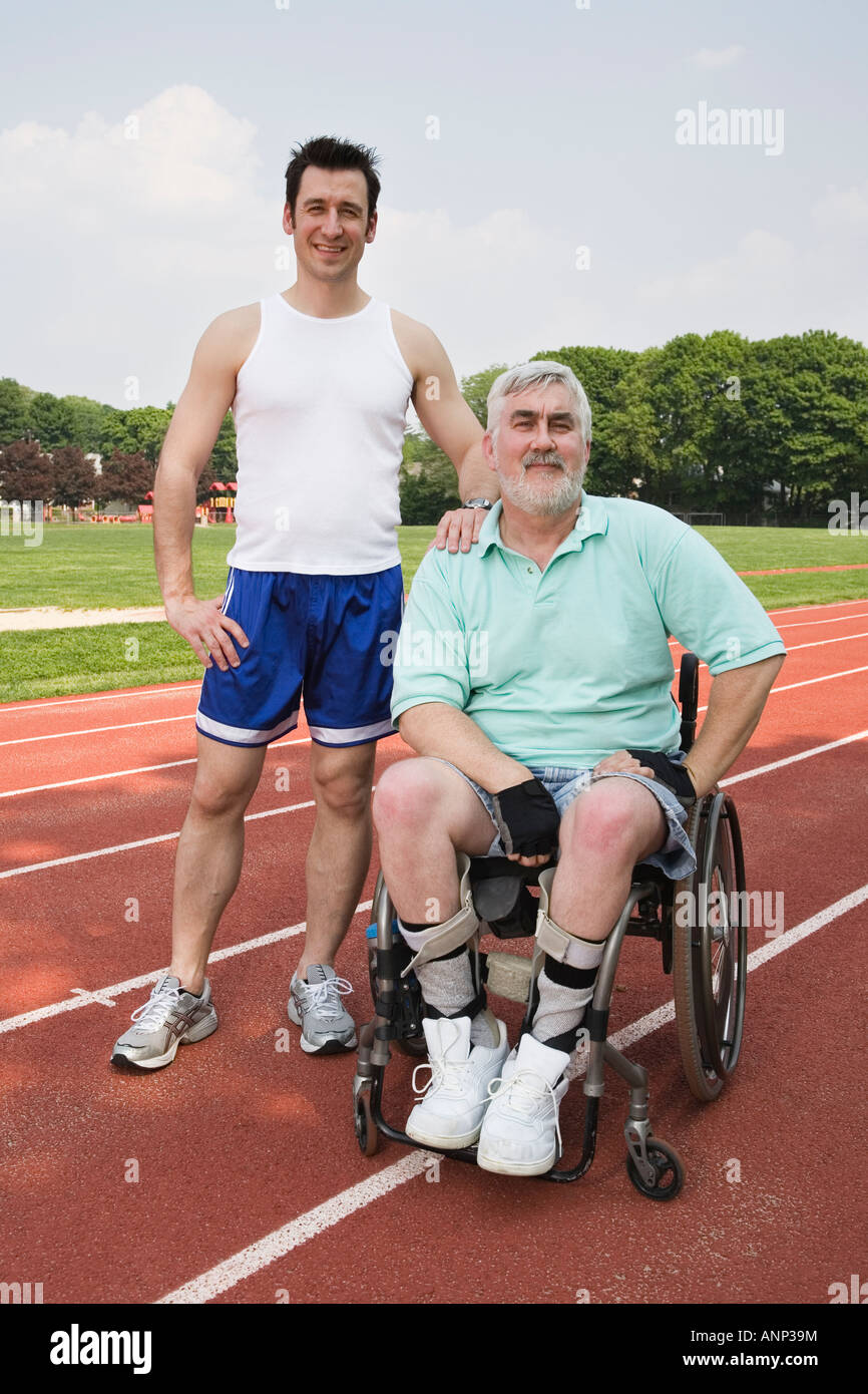 Portrait of a handicapped senior man and a young man smiling Stock ...