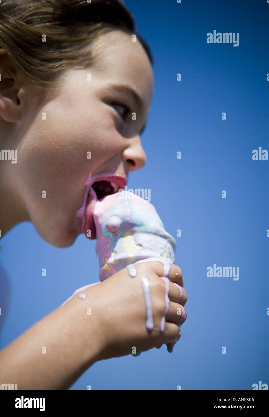 Profile of a girl eating an ice cream cone Stock Photo - Alamy