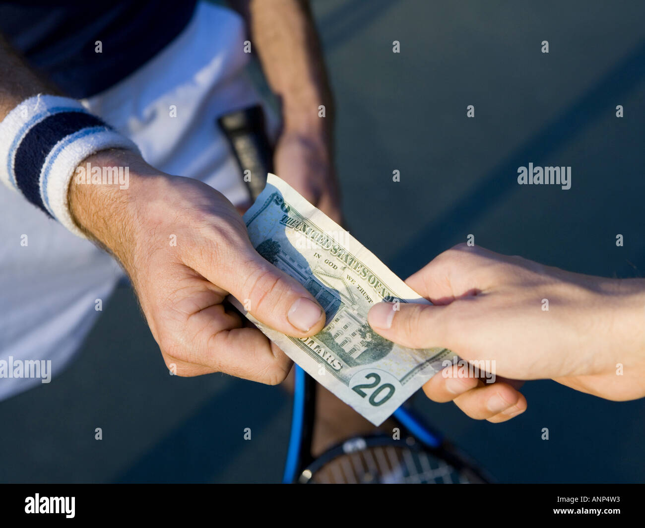 Close up of a man giving a twenty dollar bill to another person Stock ...